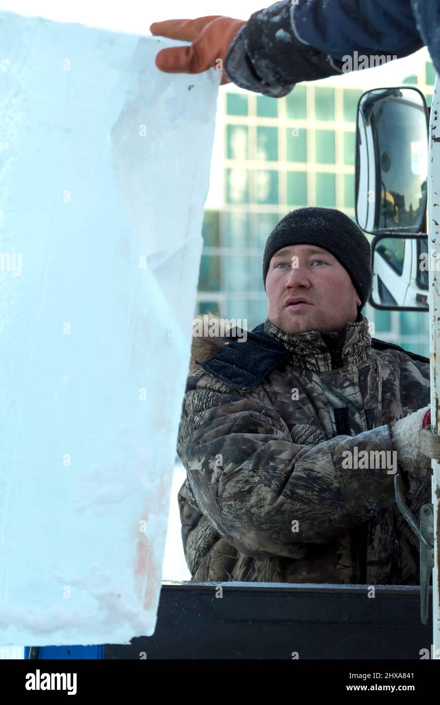 The crane driver raised the ice panel high above the ground Stock Photo ...