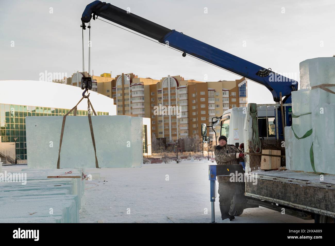 The crane driver raised the ice panel high above the ground Stock Photo ...