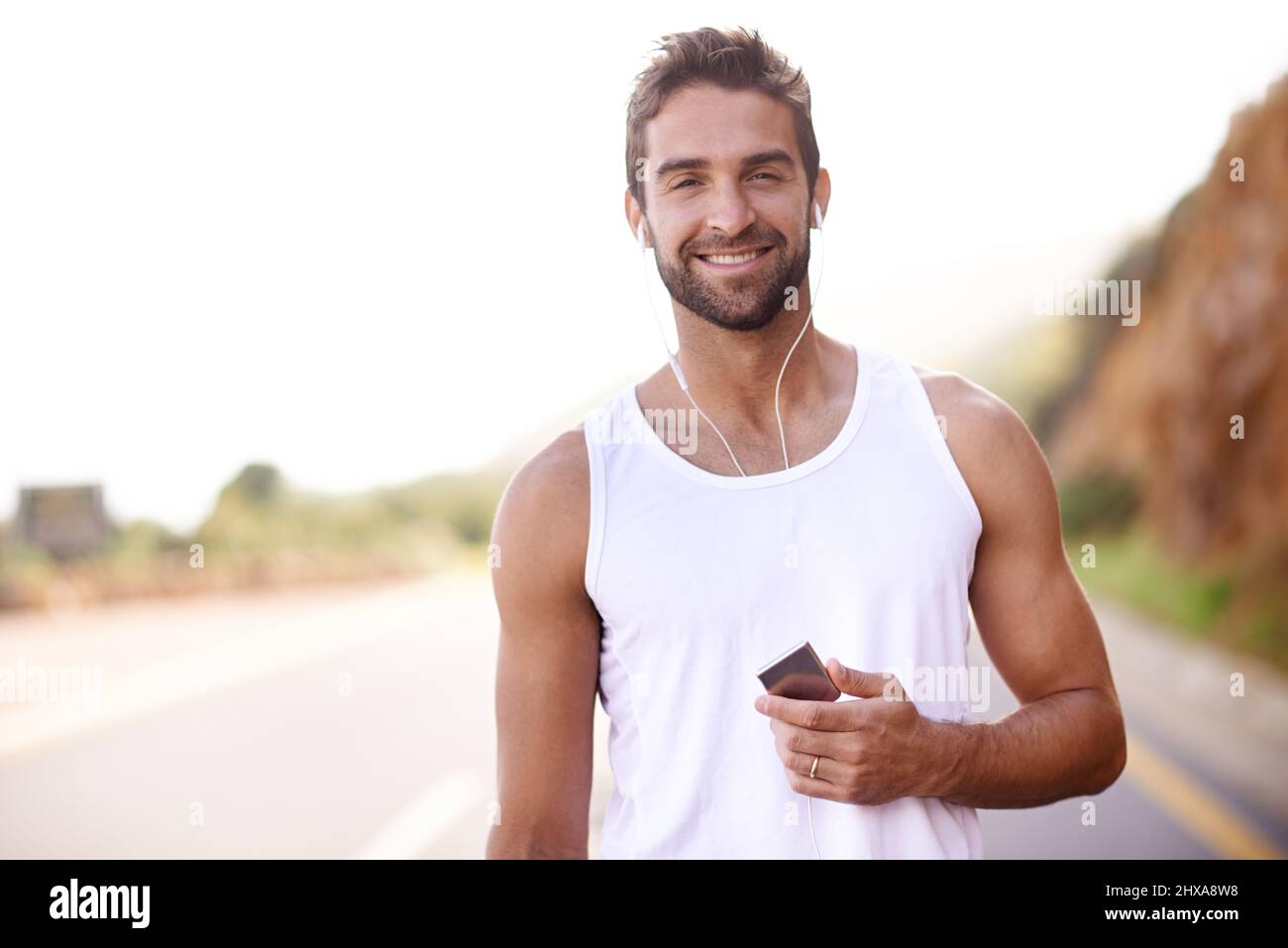 Selecting an album to accompany him on his run. Portrait of a handsome ...