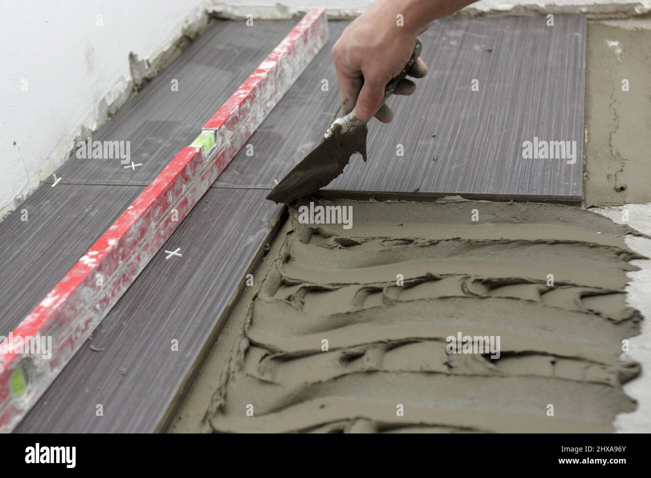 Laying Ceramic Floor Tiles In A Small Room Stock Photo - Alamy