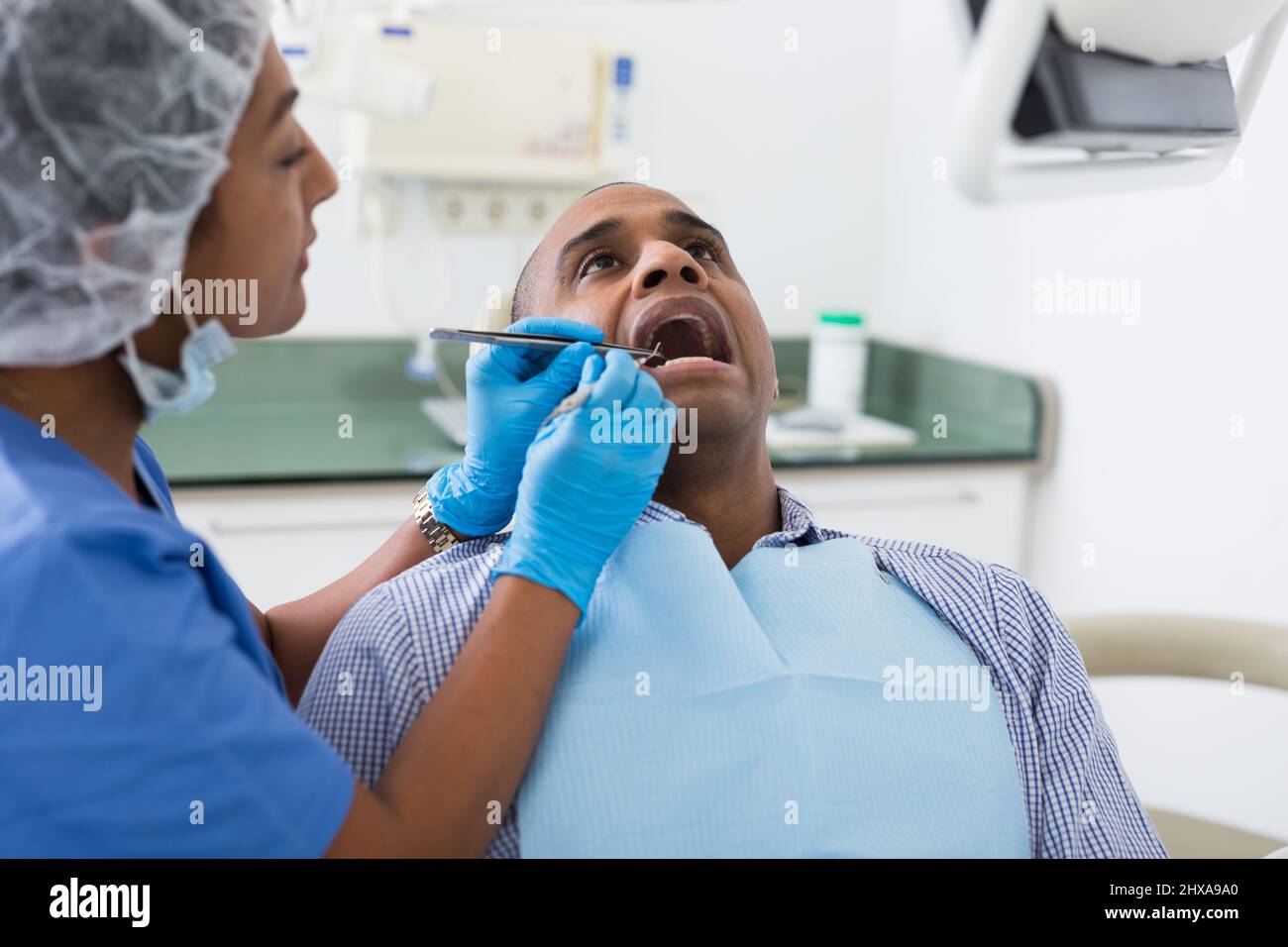 Man sitting with open mouth during dental checkup at dentist Stock ...
