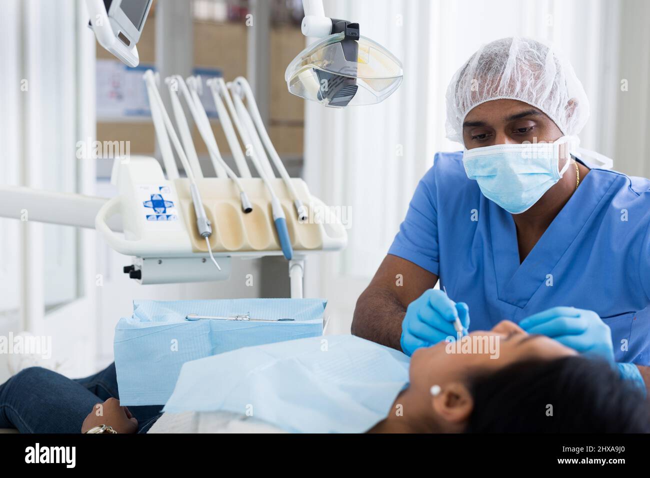Dentist checking teeth of patient woman sitting in medical clinic Stock ...