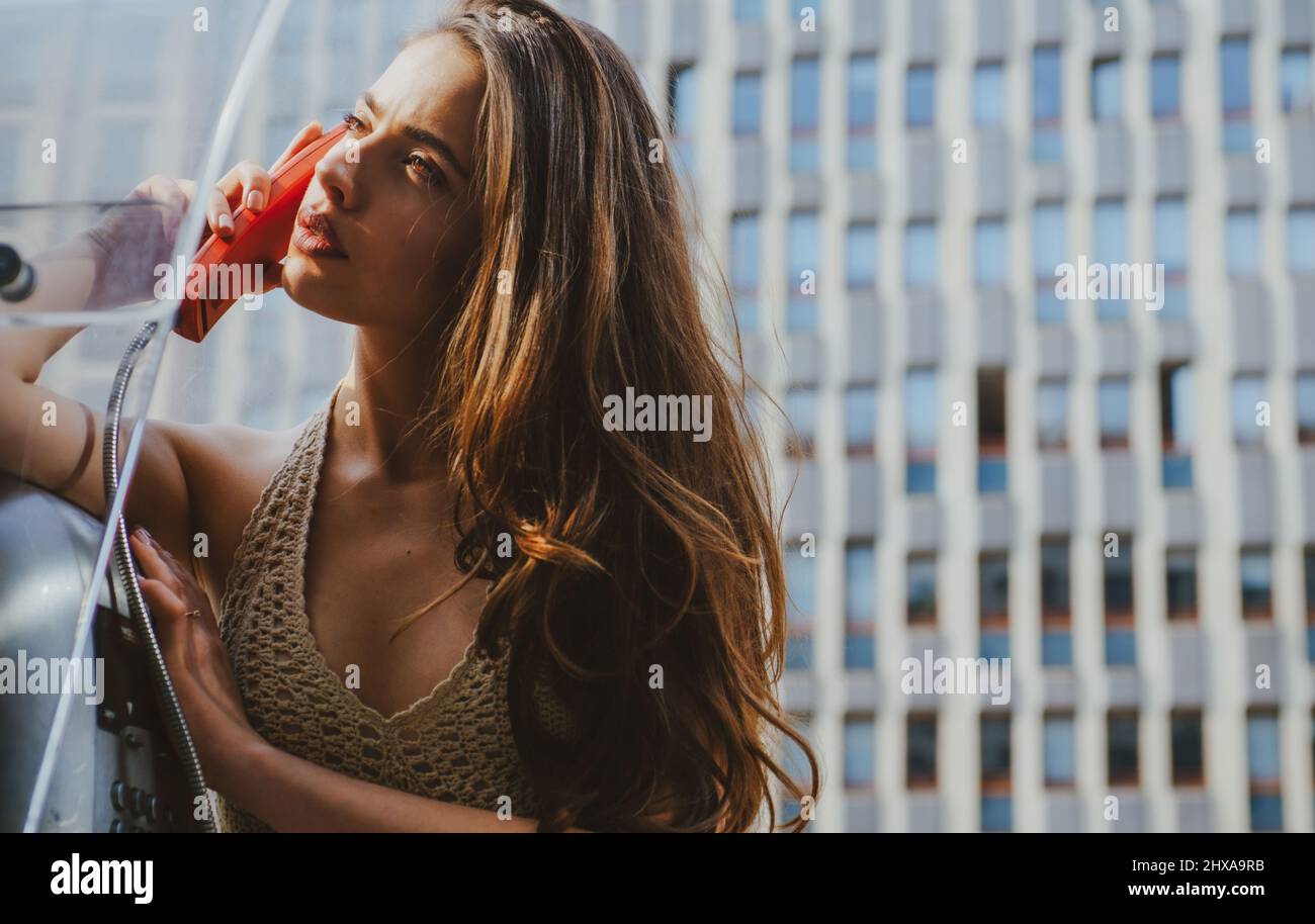 Pretty woman with payphone. Oldfashion town. Vintage concept ...