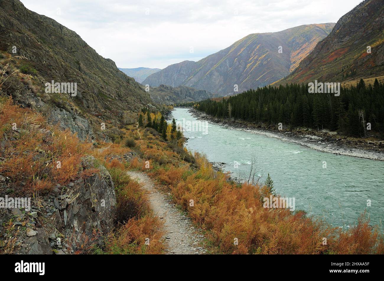 The path along the mountainside along the flowing beautiful turquoise ...