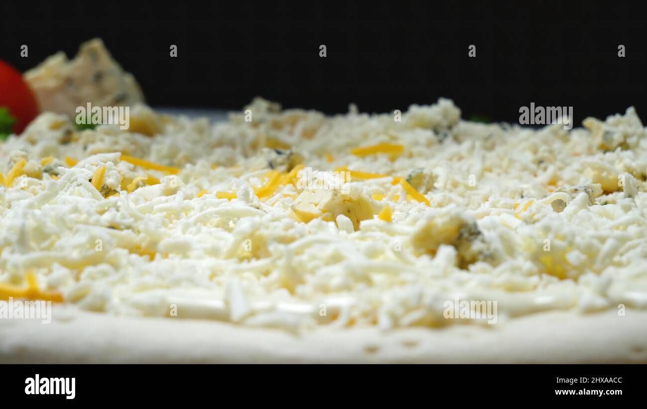 Chef pours cheese on pizza. Frame. Professional chef of Italian cuisine ...