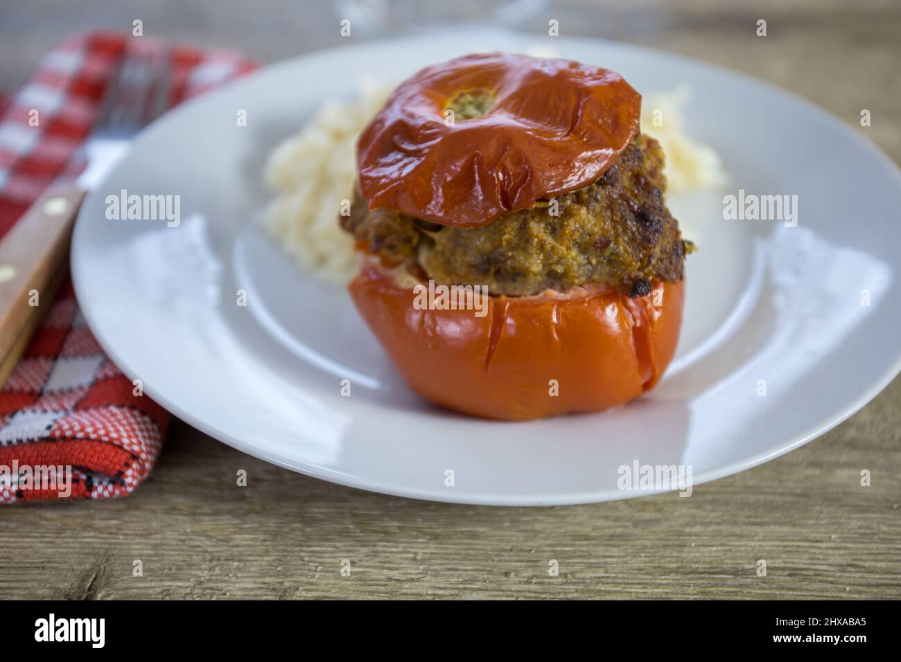 stuffed tomato cooked with rice on a plate Stock Photo - Alamy