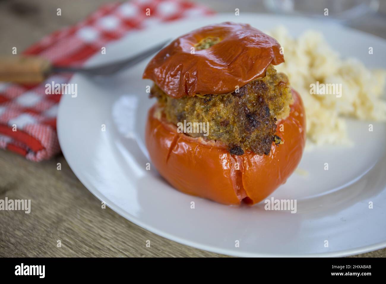 stuffed tomato cooked with rice on a plate Stock Photo - Alamy