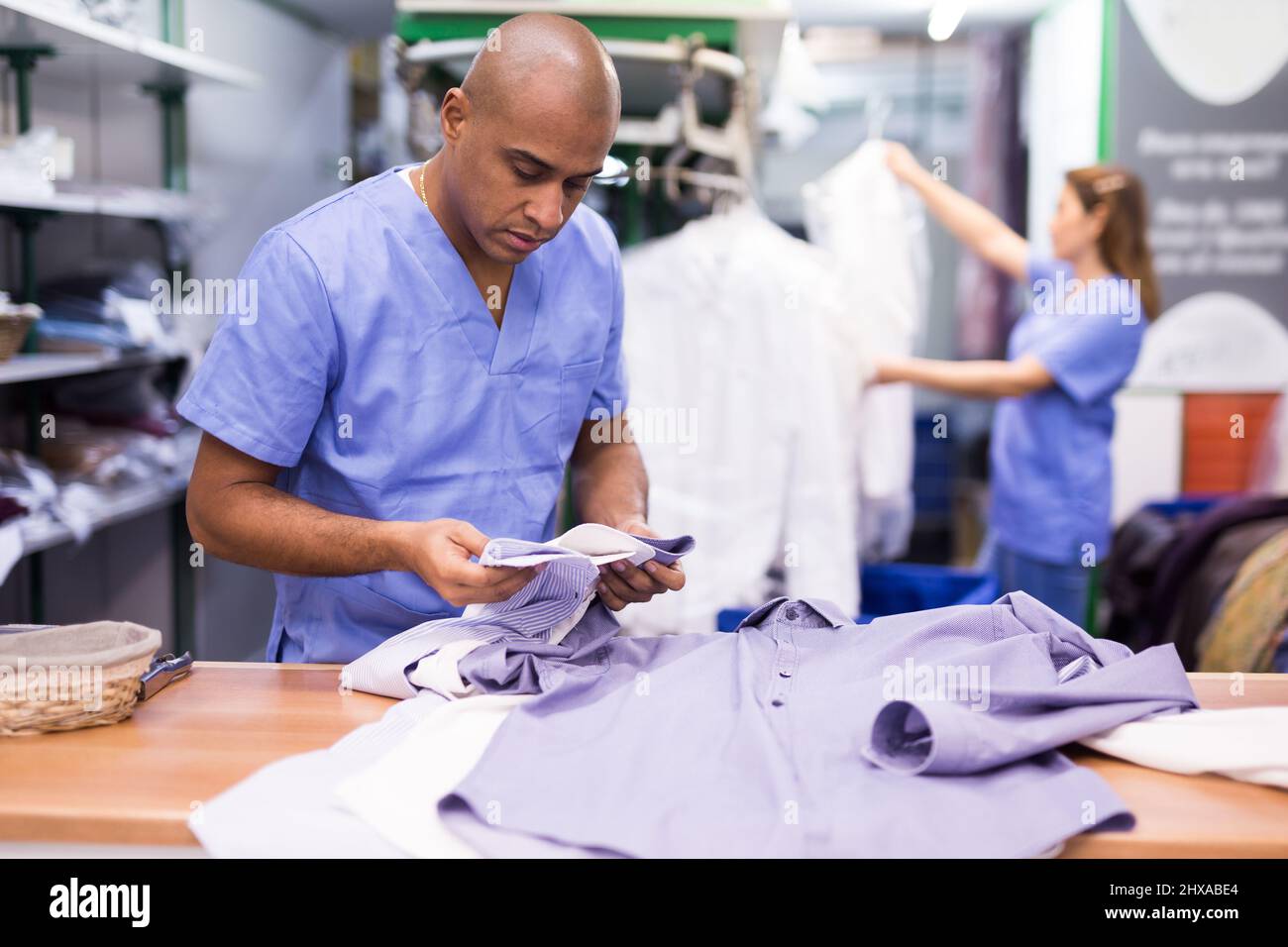 Male laundry worker checking hi-res stock photography and images - Alamy