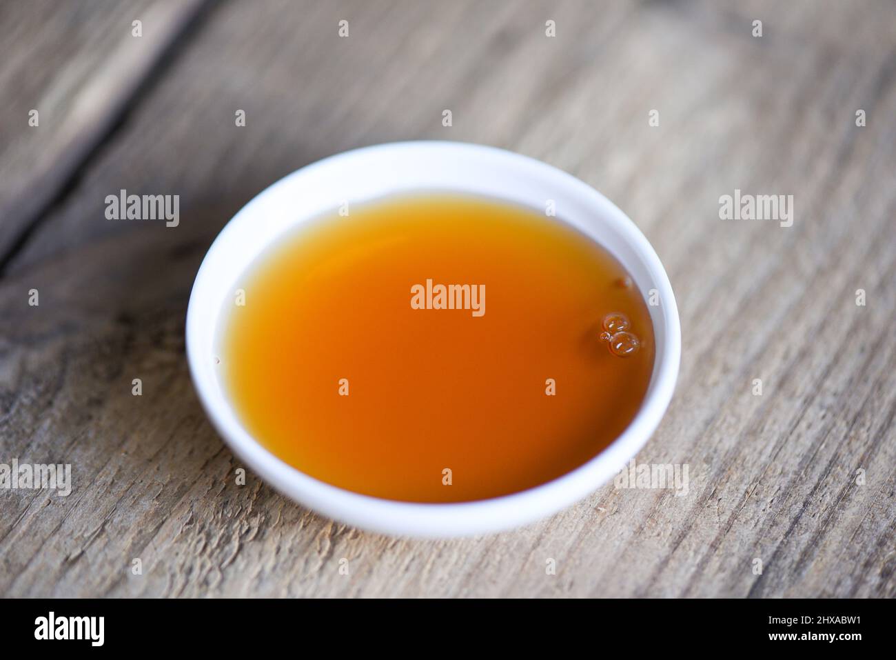 fish sauce on white bowl on wooden background, fish sauce obtained from ...