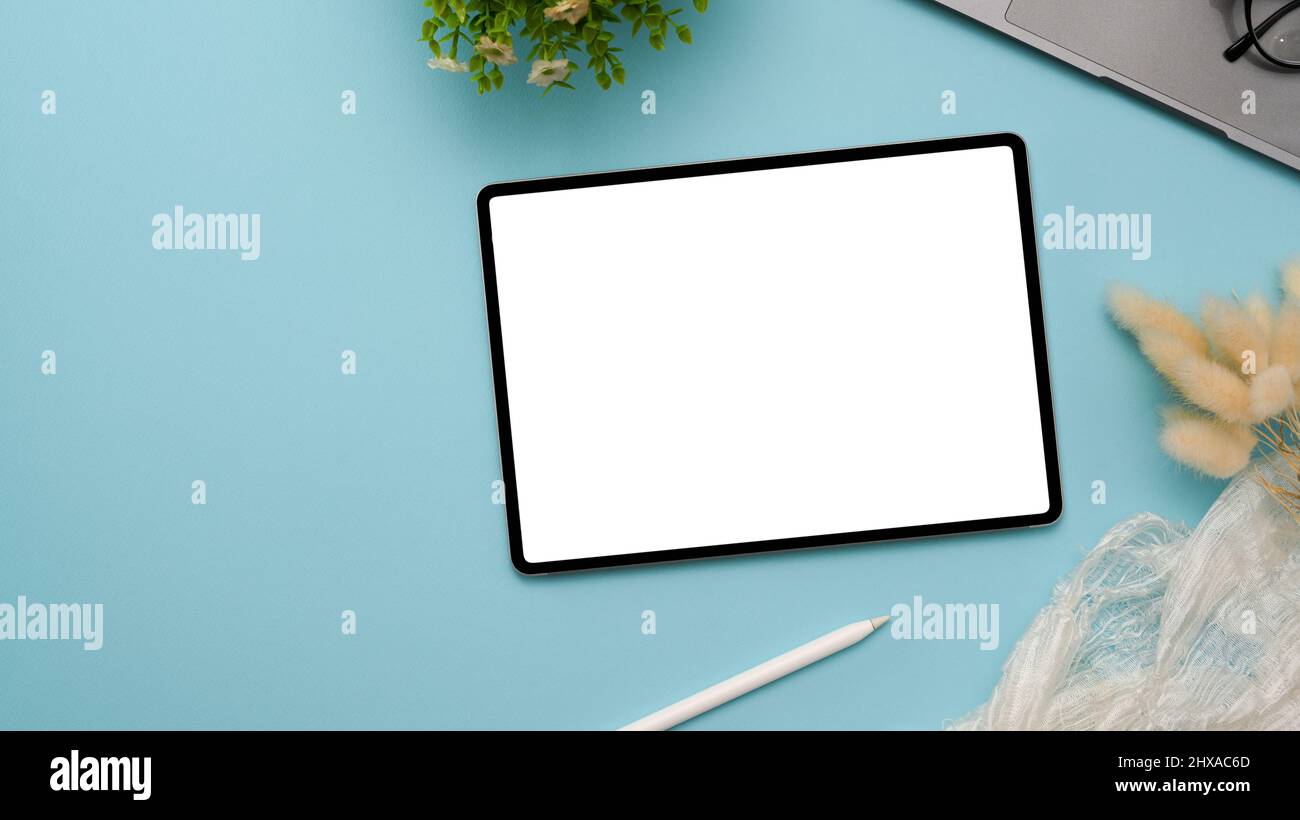 Overhead shot of a graphic tablet touchpad white screen mockup, stylus ...