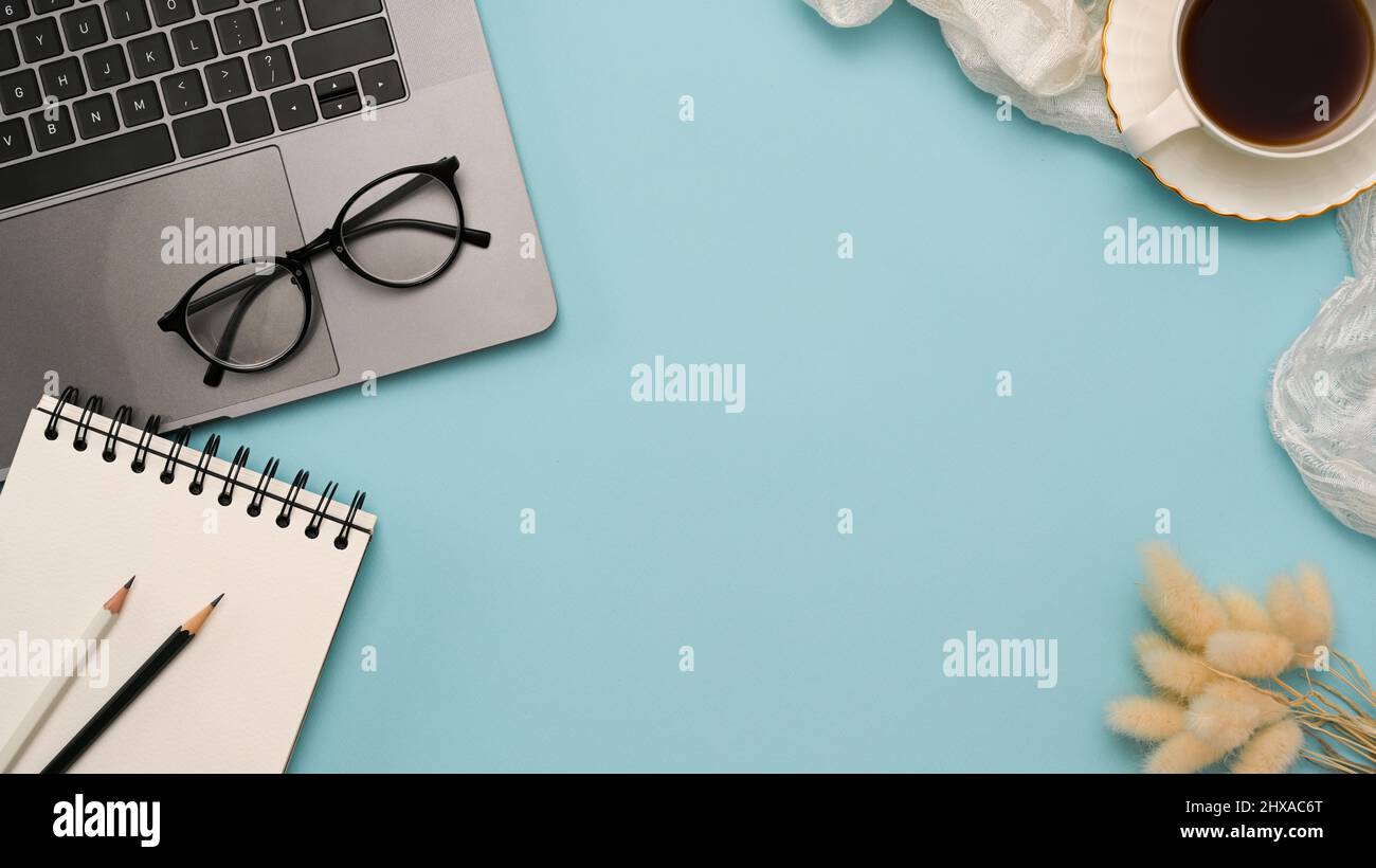 Top view, Stylish blue office desk background with laptop computer ...