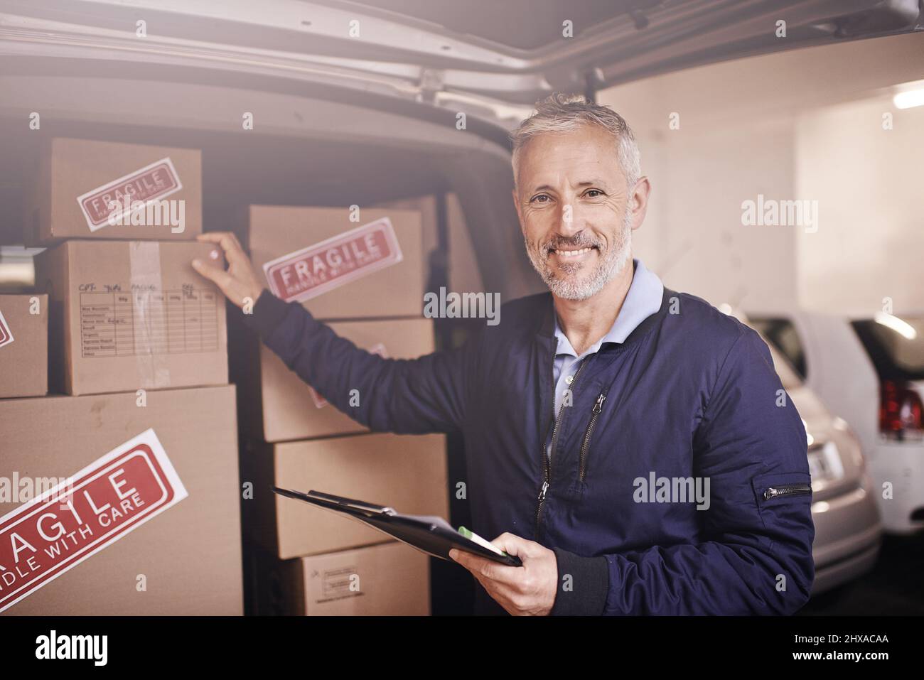 Getting your package delivered on time every time. Portrait of a mature ...