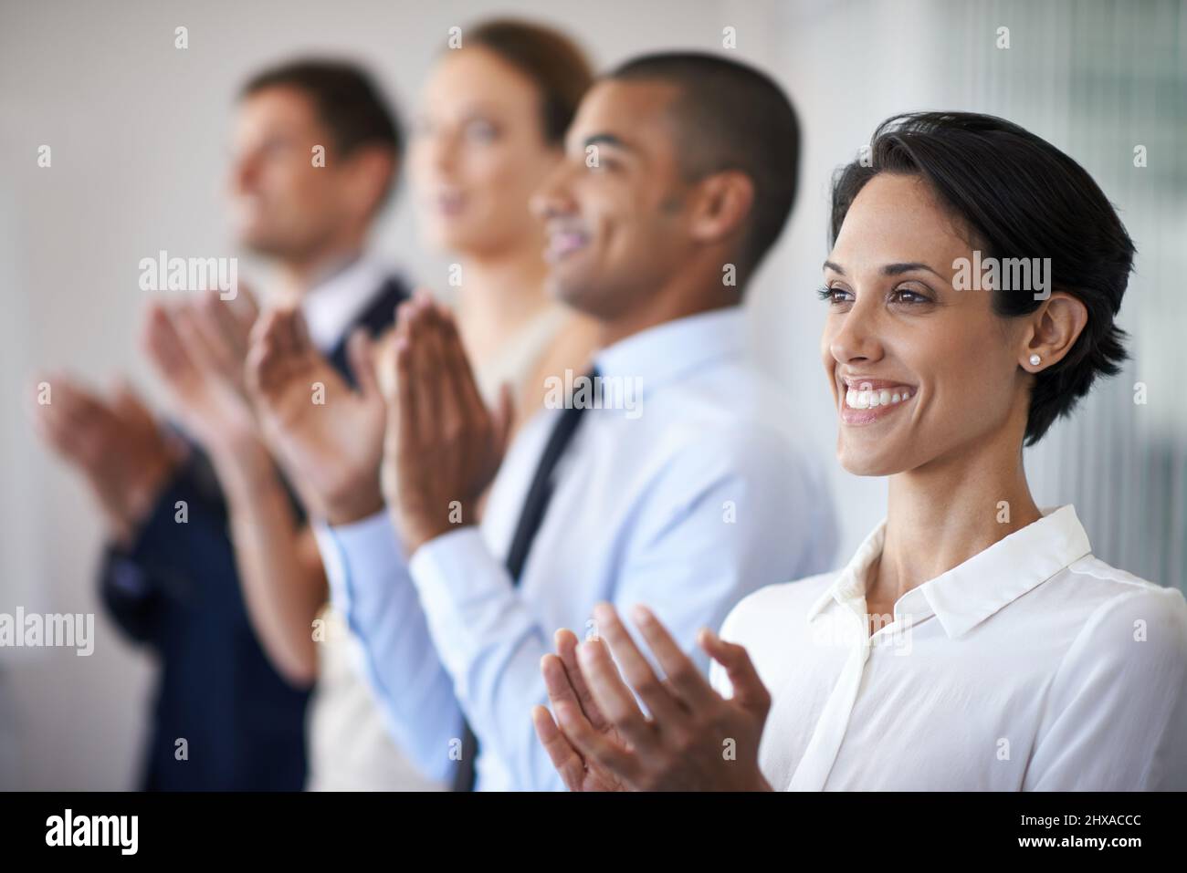 Thats something to celebrate. Shot of a row of smiling colleagues ...