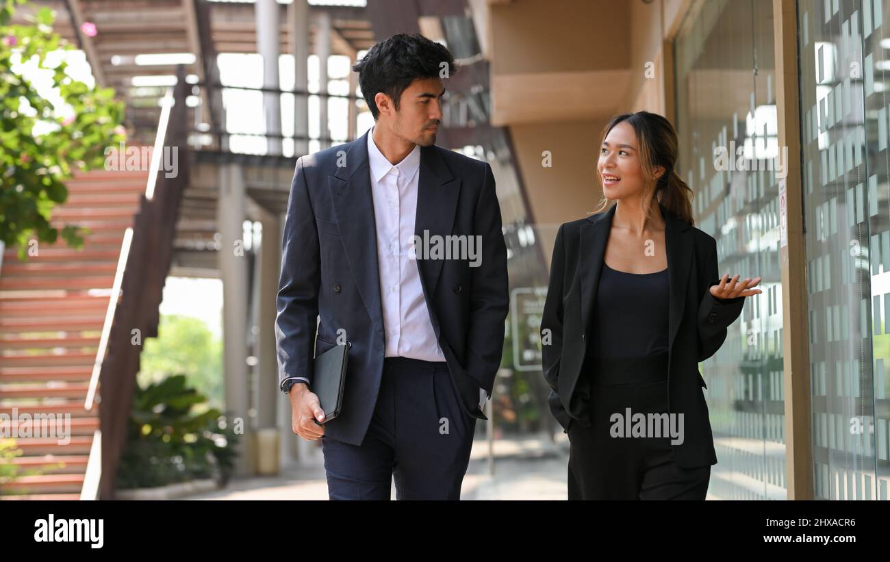 Successful male boss and female executive manager chatting while ...