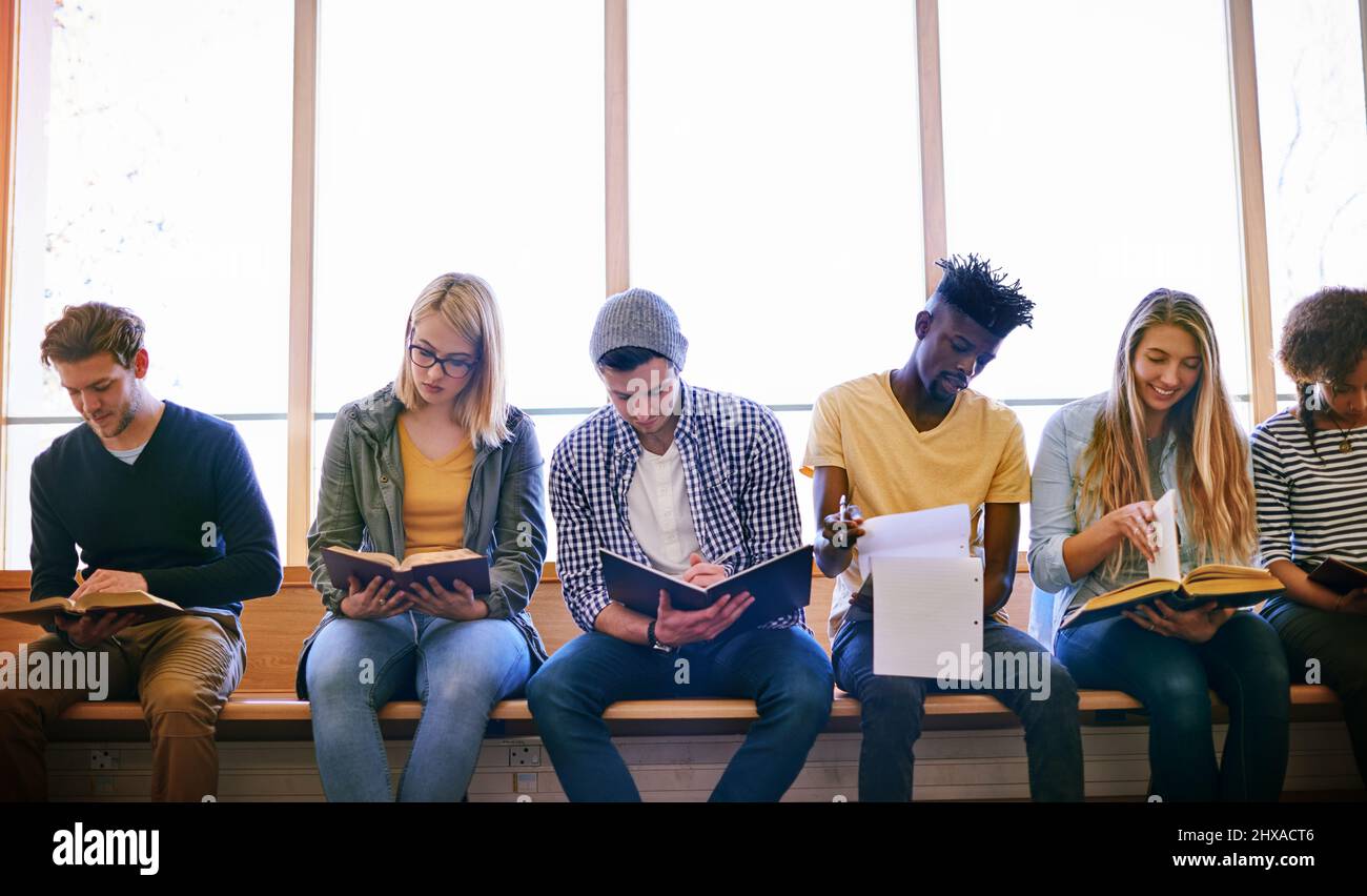 Final exams are coming up soon. Shot of a group of university students ...
