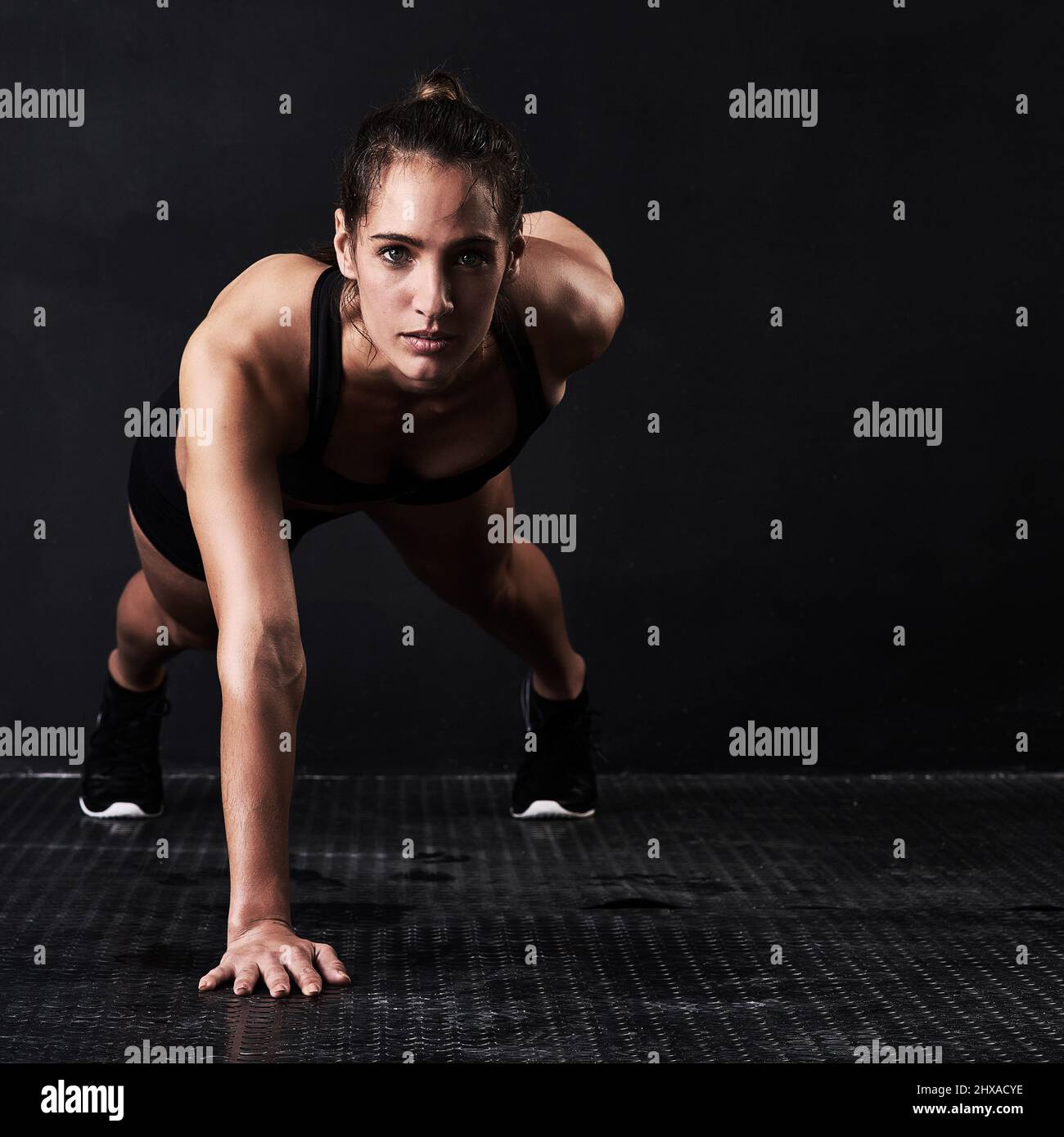 Defined by strength. Studio portrait of a woman working out against a ...