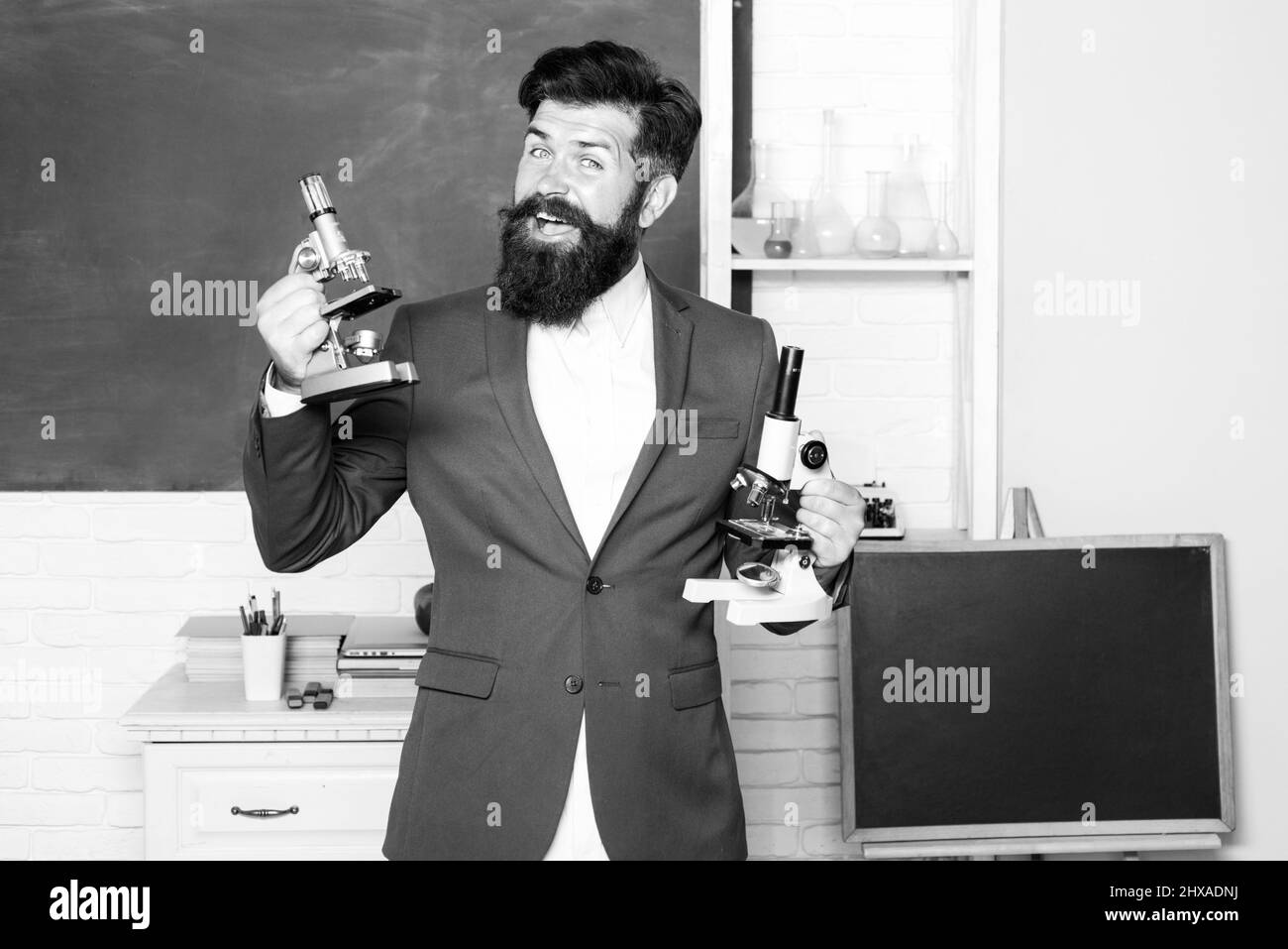 Portrait of happy smiling teacher with microscope, professor, tutor ...