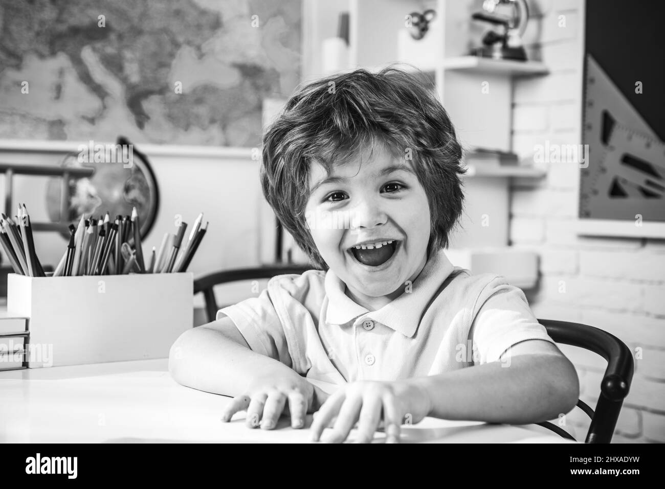 Surprised pupil. Beginning of lessons. Little ready to study. Happy ...