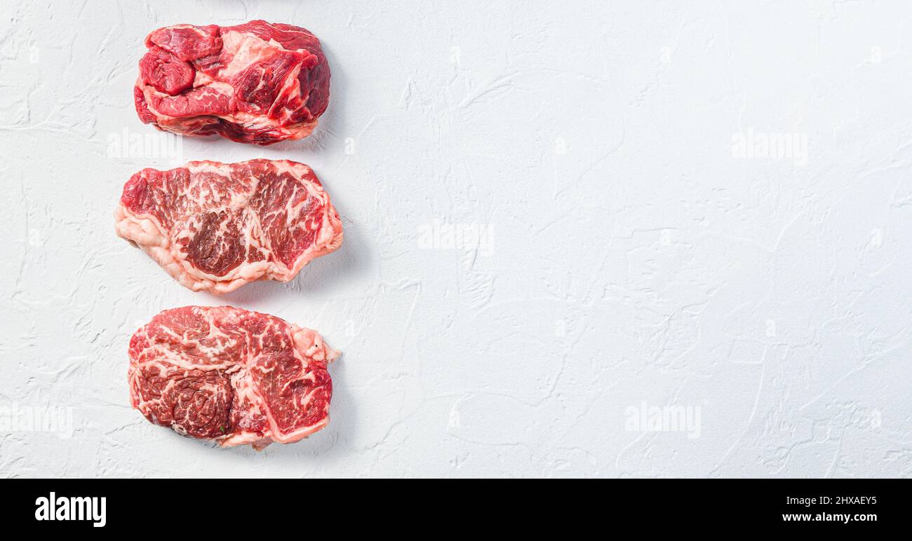 A set of different types of raw beef steaks:top blade, rump, chuck eye ...