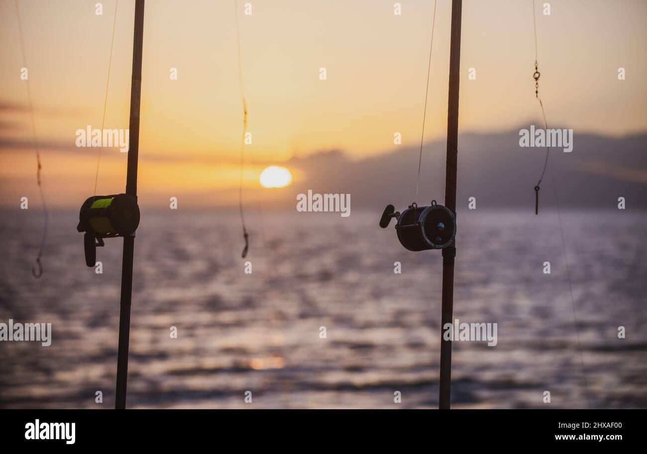 Fishing rods over a beautiful seascape. Sanset on sea Stock Photo - Alamy