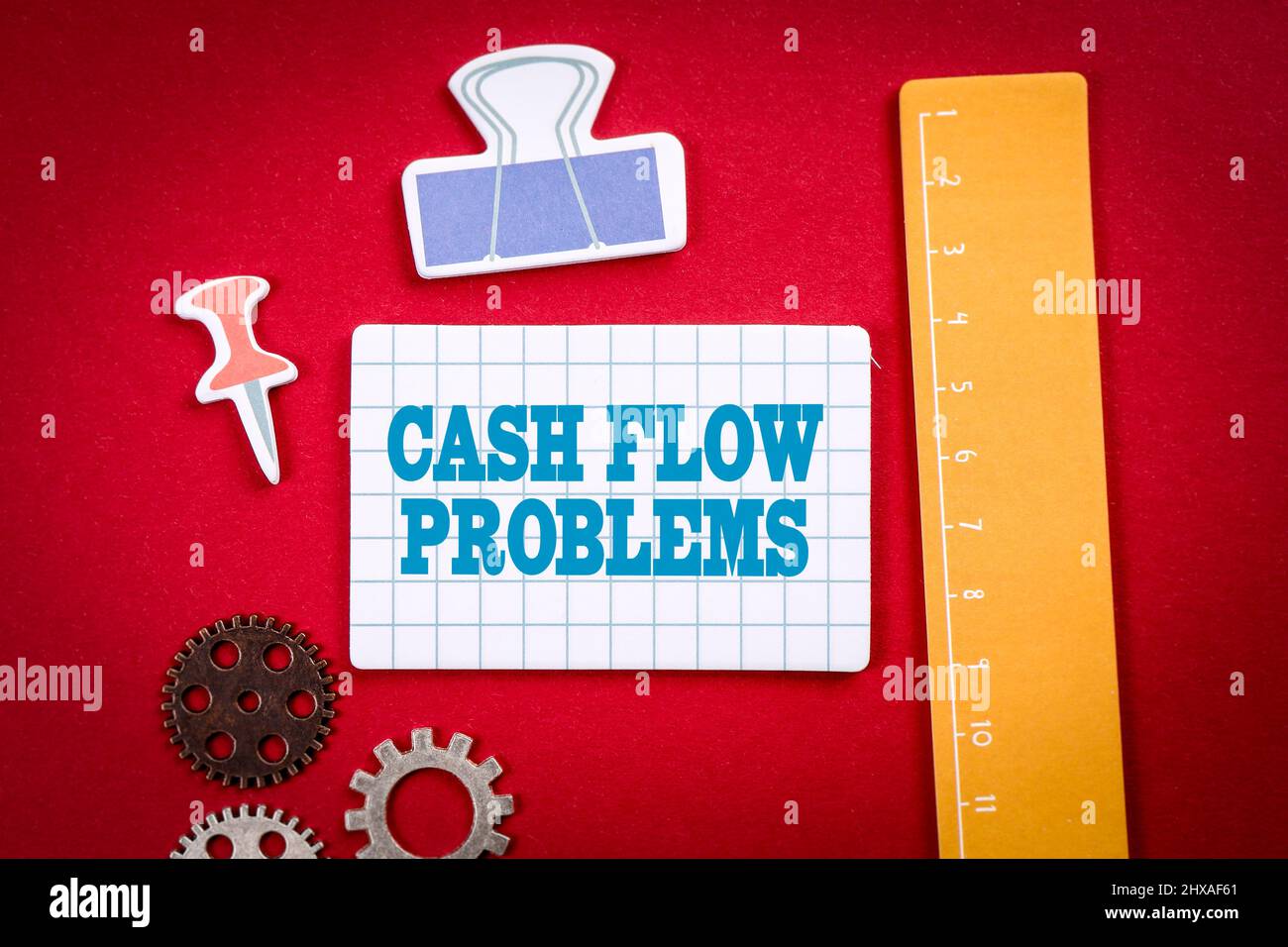 Cash Flow Problems. Office and learning supplies on a red background ...