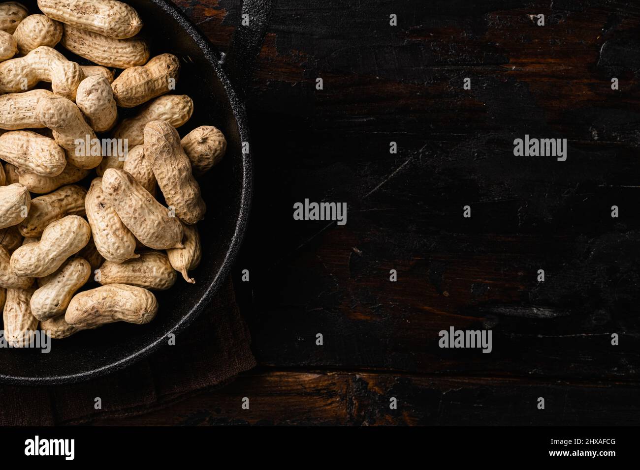 Peanuts serving to make oil, peanut butter set, on old dark wooden ...
