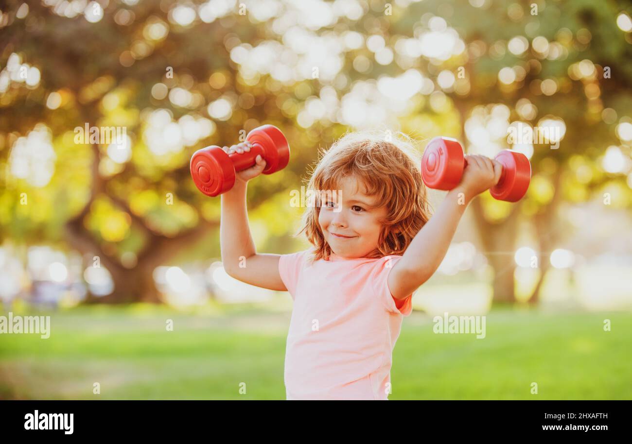 Boy workout in park. Kid sport. Child exercising with dumbbells. Sporty ...