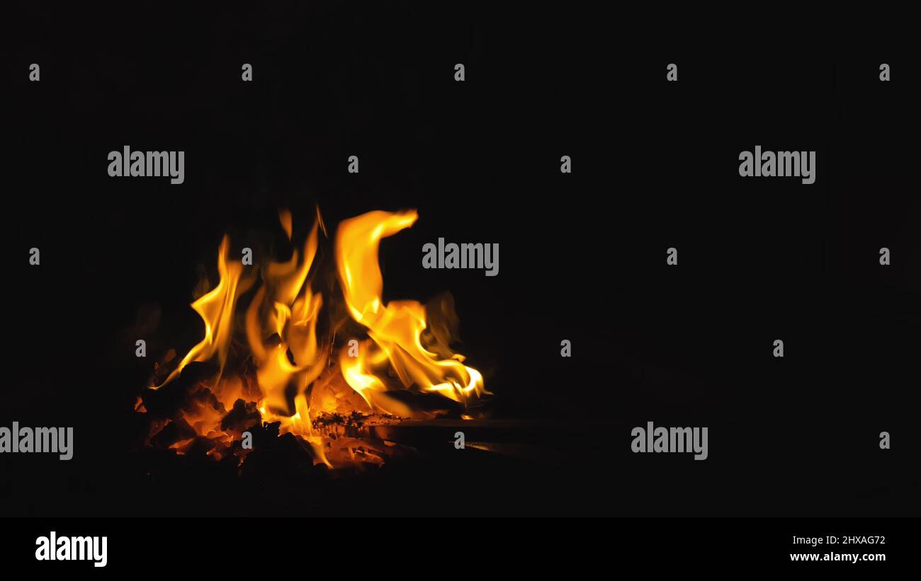 Forge fire in furnace. Blacksmith tempers a steel product in a stove ...