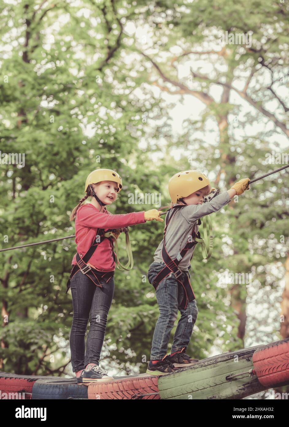 Hike and kids concept. Child boy having fun at adventure park. Climber ...