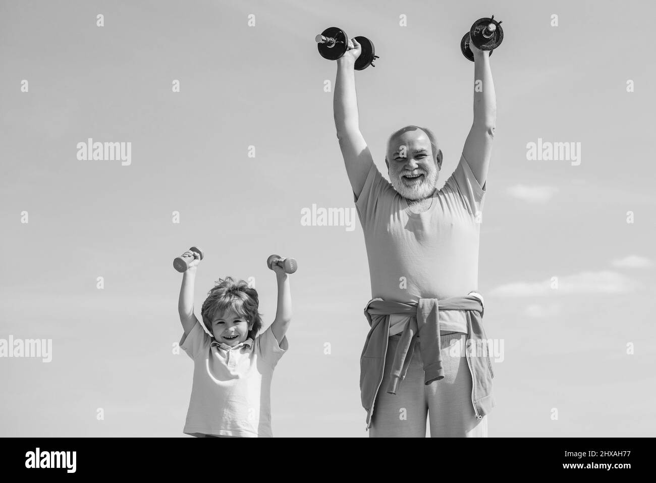 Grandfather and child in gym working out with weights. Portrait of a ...