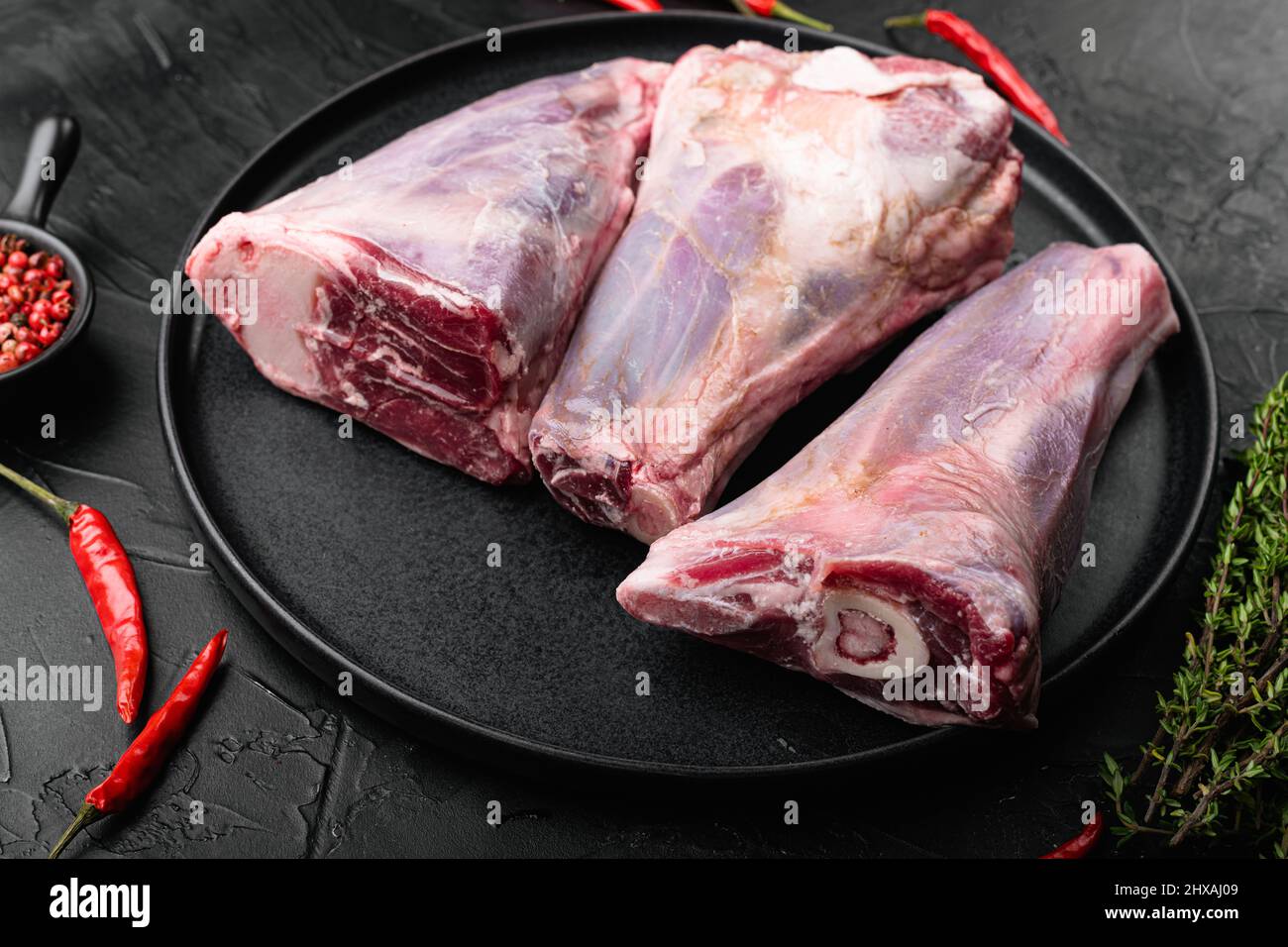 Raw lamb shanks meat set, on black dark stone table background Stock ...