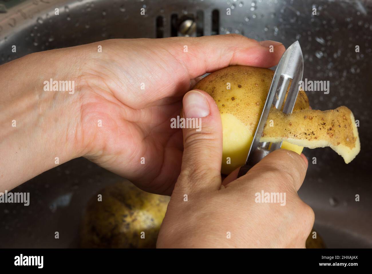 Hand holding vegetable peeler hi-res stock photography and images - Alamy