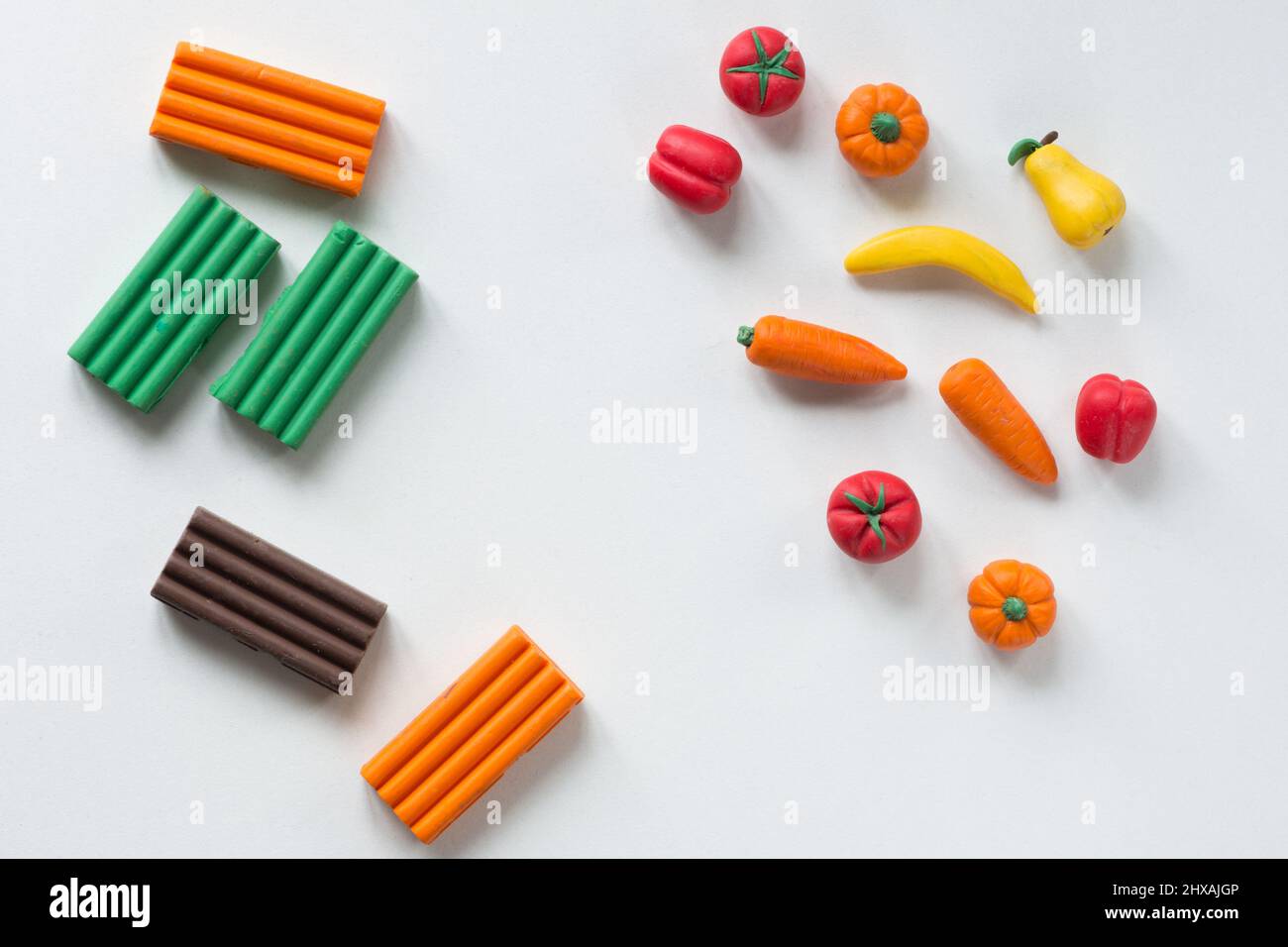 Pieces of polymer clay and handmade fruits and vegetables from it on ...