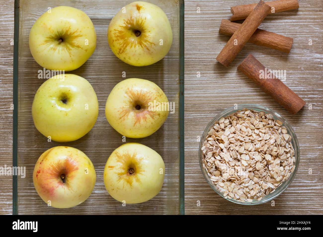 Top view of apples oats cinnamon sticks as ingredients for baked apples ...