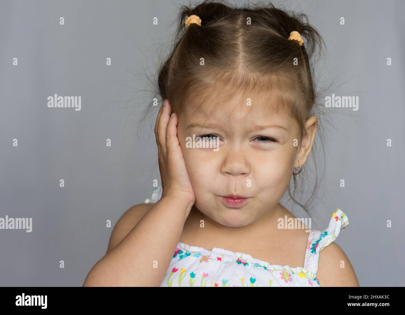 Portrait of little girl showing toothache on the white background Stock ...