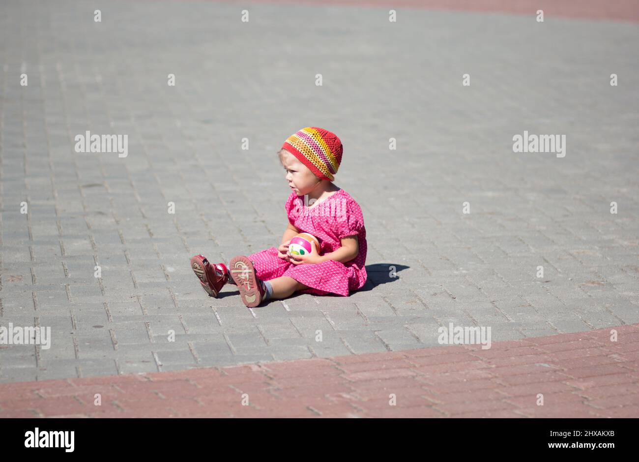 alone child sitting on the ground in the summer park Stock Photo - Alamy
