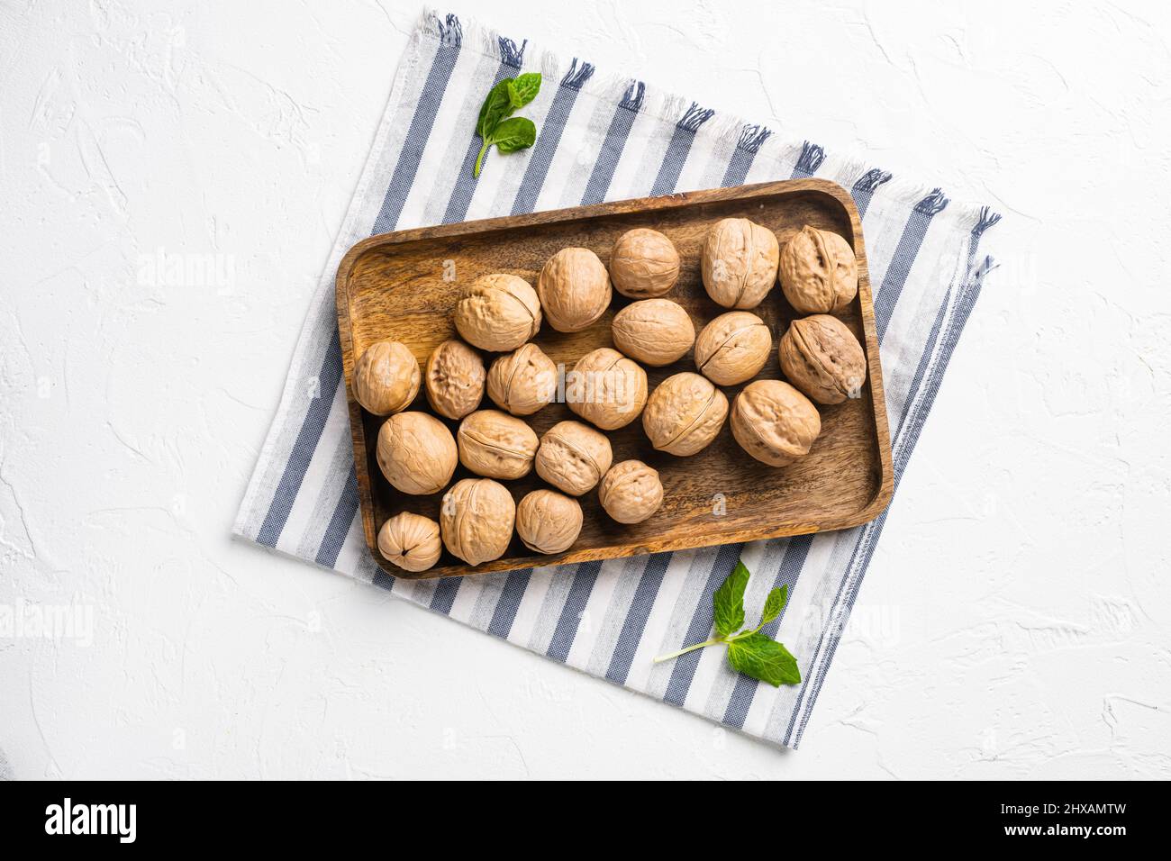 Walnut whole nut set, on white stone table background, top view flat ...
