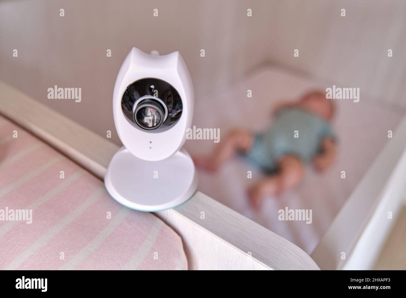 Baby monitor camera watching over a Caucasian baby while he sleeps in ...