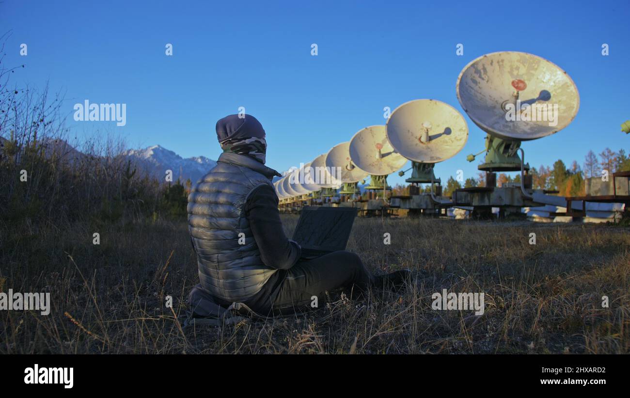 Hacker hacks the radio telescope using notebook. Man to program hacking ...