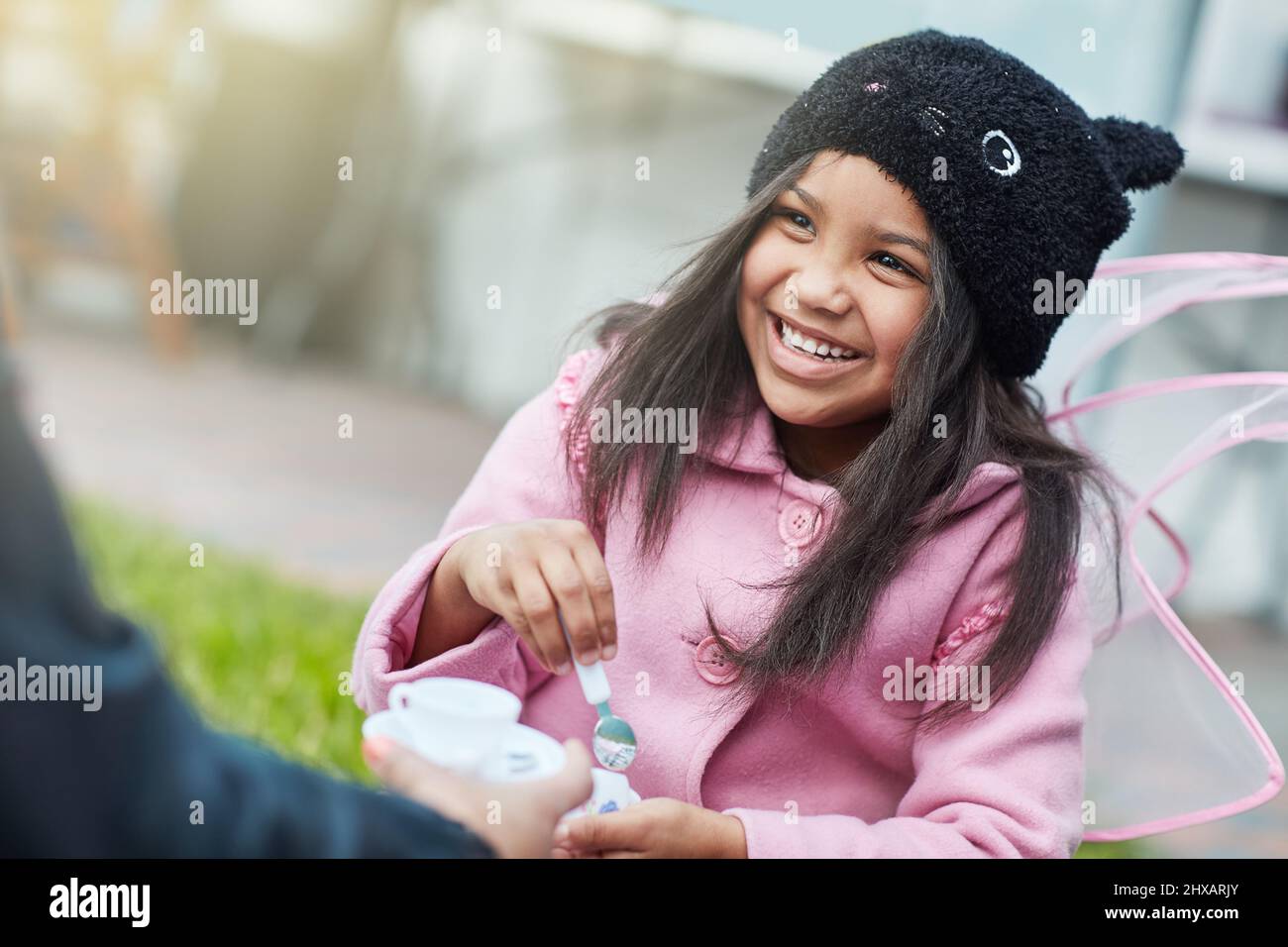 How nice of you to join me for tea. Shot of a cute little girl having a ...