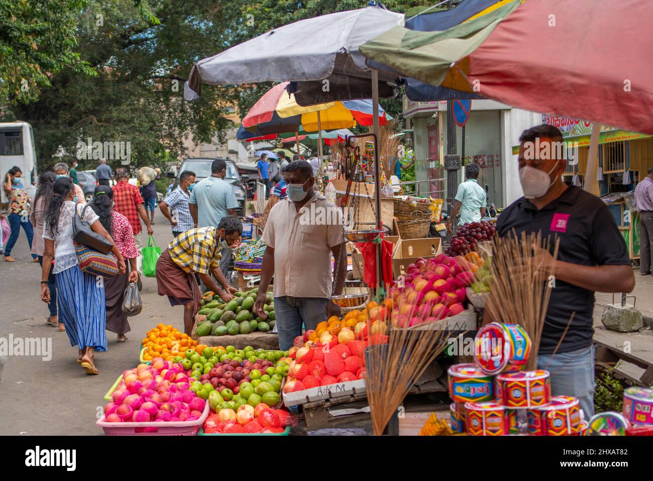 KANDY, SRI LANKA - MARCH 20: People walking in front of fruit stalls on ...