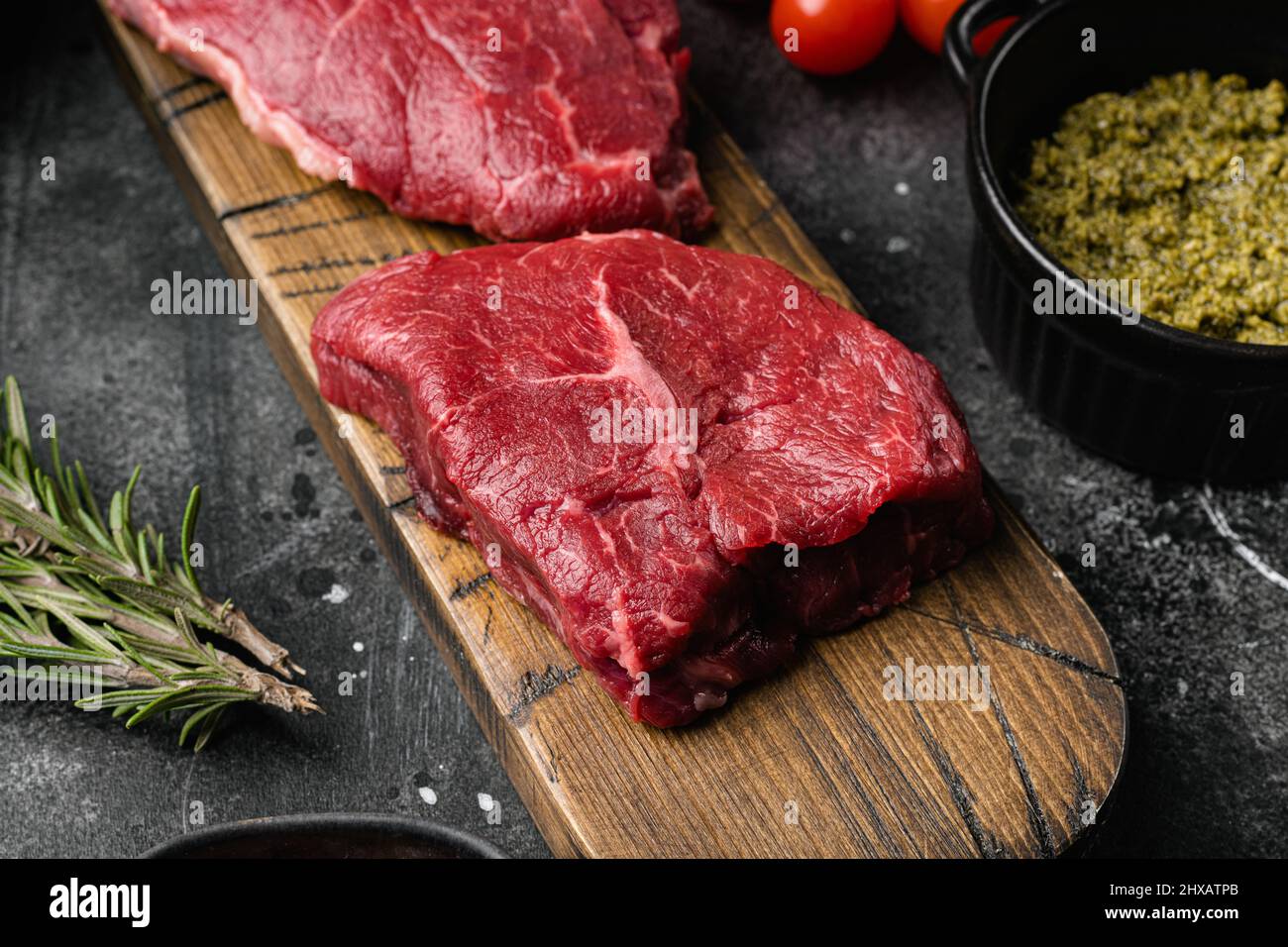 Fresh raw Beef meat Rump Steak set, on black dark stone table ...
