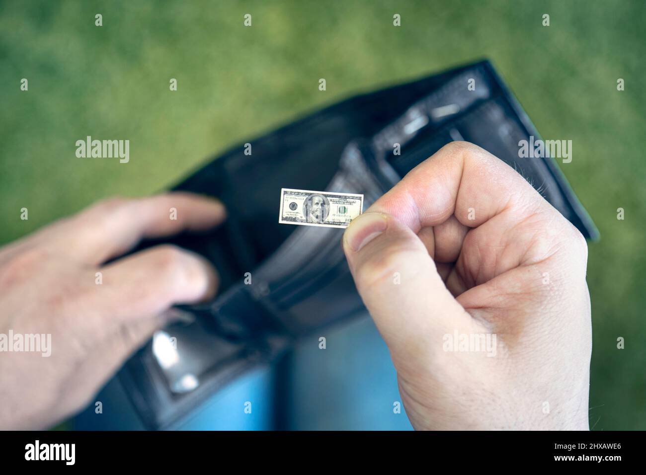 Hand holding miniature dollar note. the concept of dollar inflation. A ...