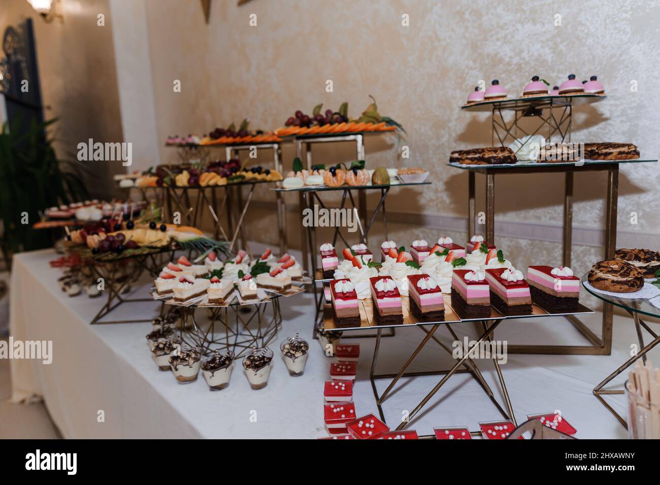 Sweet cakes at a wedding banquet. Catering, sweet festive buffet Stock ...