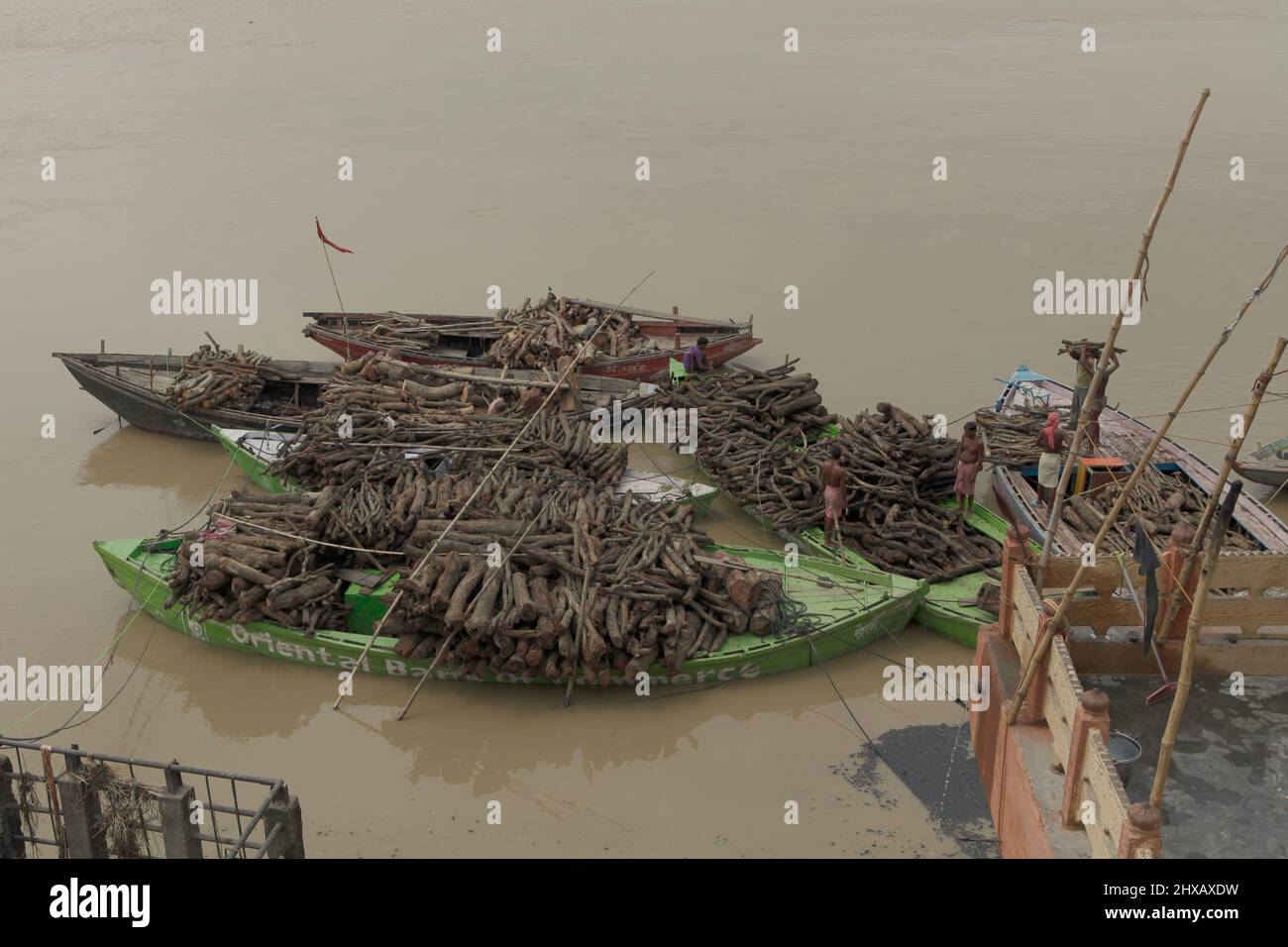 Boats loaded with firewood for cremation ceremonies on River Ganges ...