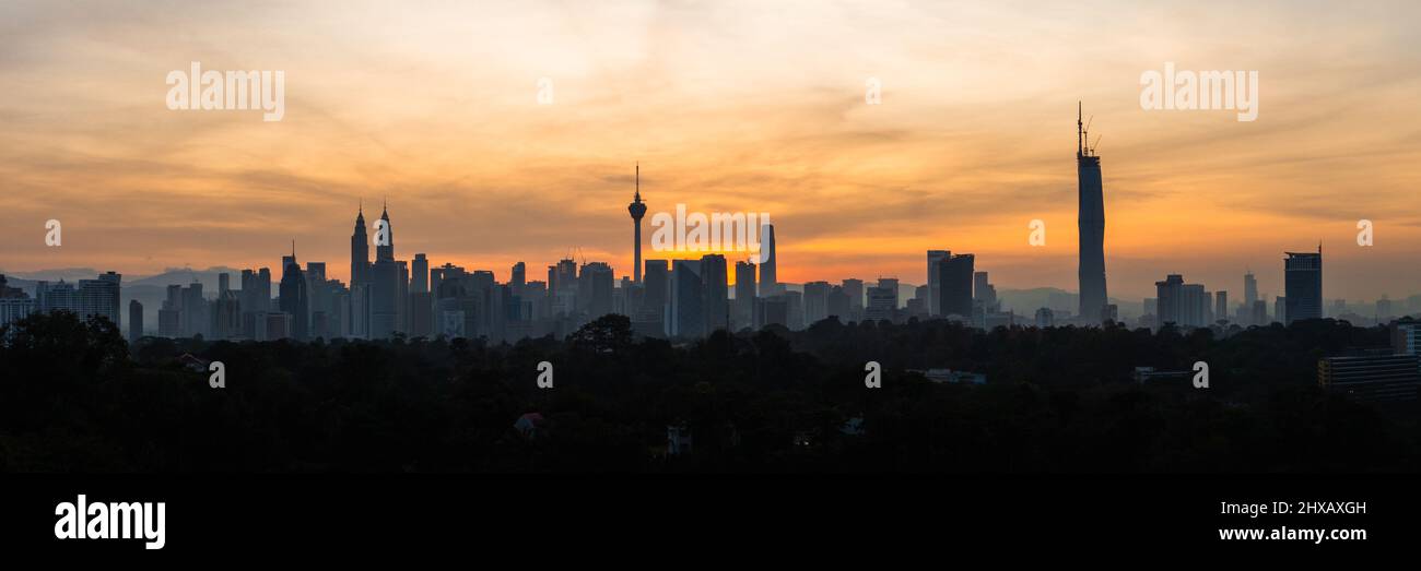 The Kuala Lumpur skyline at sunrise with the the Petronas Twin Towers ...
