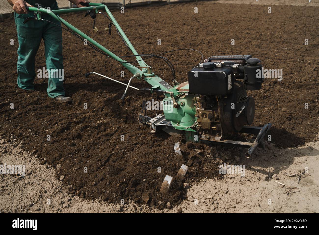 Modern farming, technology agriculture. Gardener man cultivate ground ...