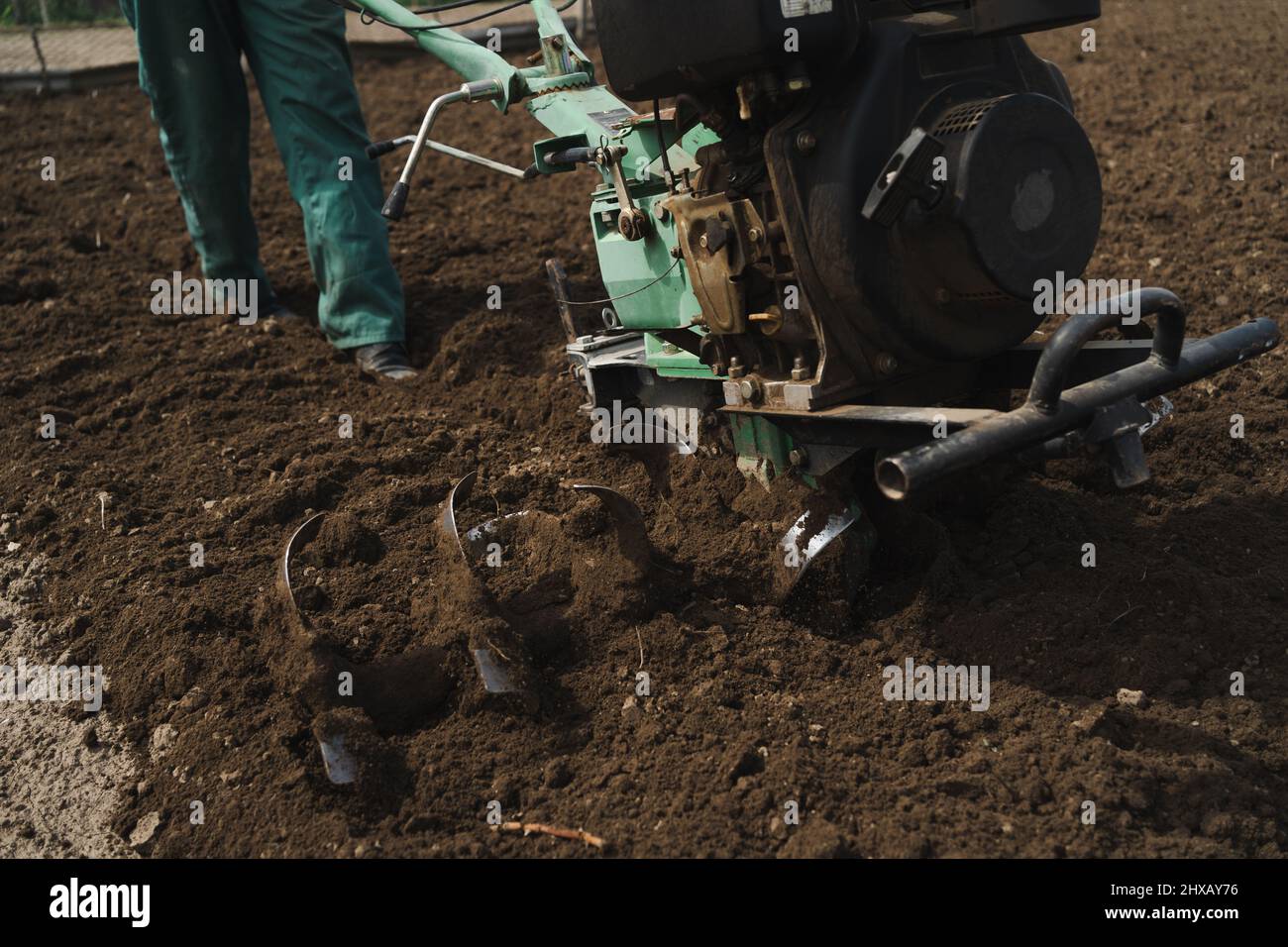 Modern farming, technology agriculture. Gardener man cultivate ground ...