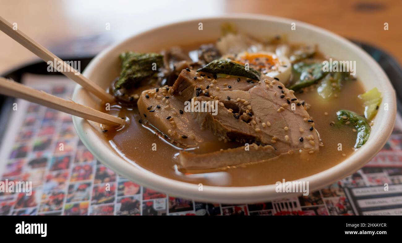 A bowl of ramen from a restaurant on a tray. Japanese ramen soup with ...