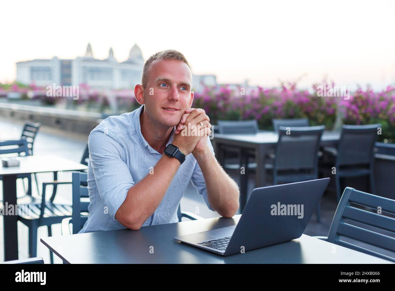 Successful young executive looking while sitting at a table with a ...